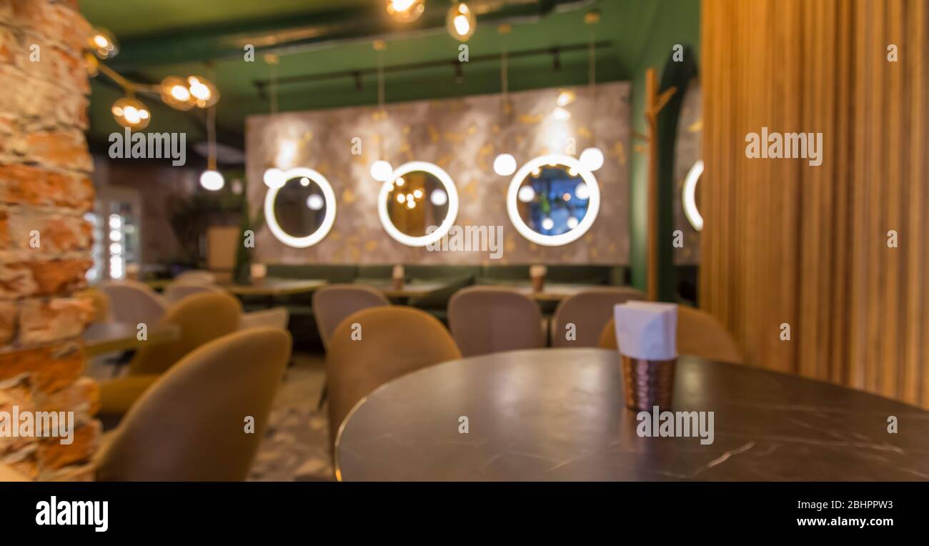 Cute restaurant interior with sofas and wooden tables Stock Photo - Alamy