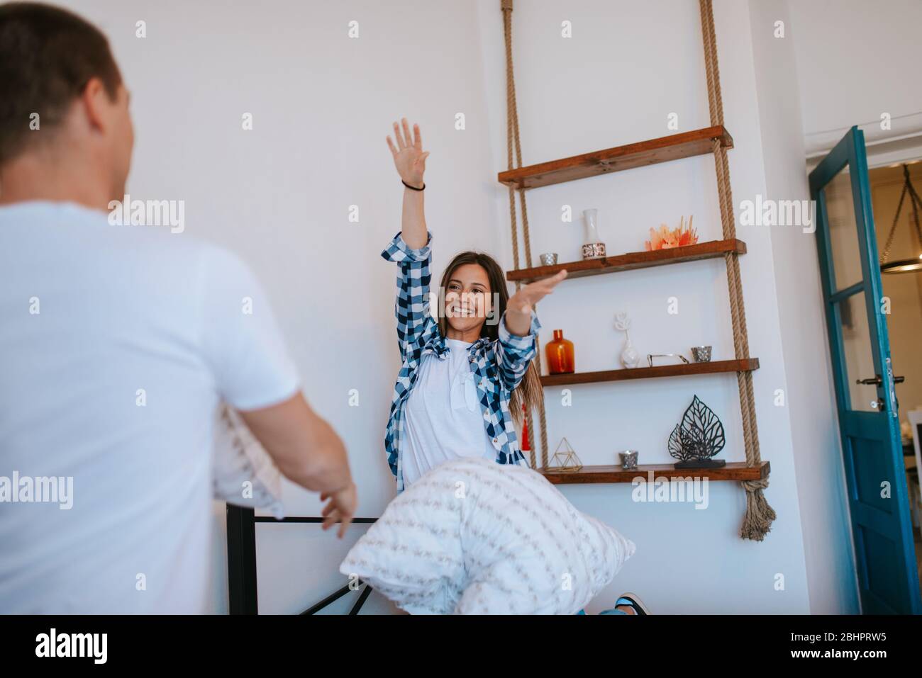 Woman hitting man with pillow hi-res stock photography and images - Alamy