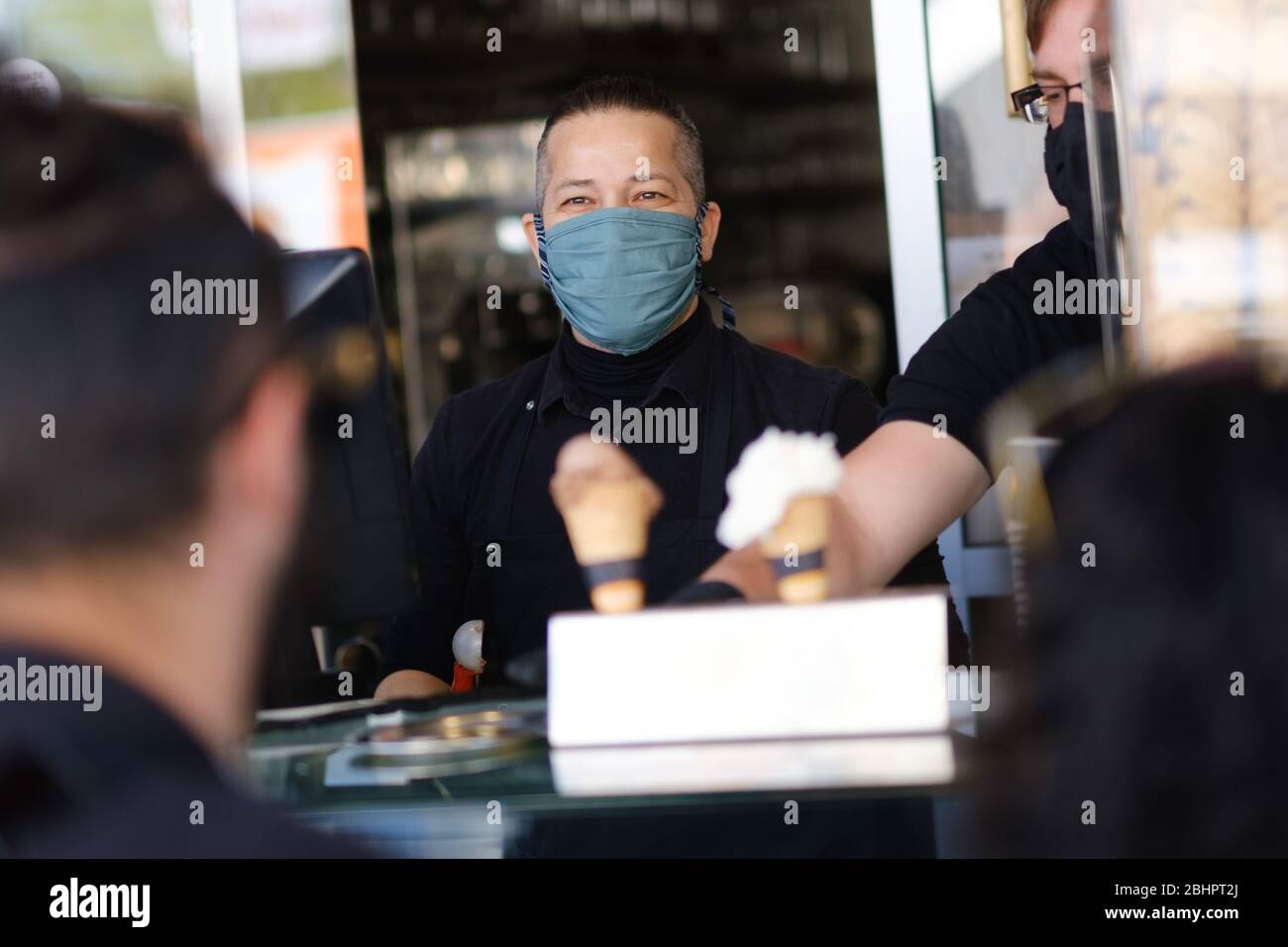 Hanover, Germany. 27th Apr, 2020. Ice cream vendor Morris wears a mouth ...