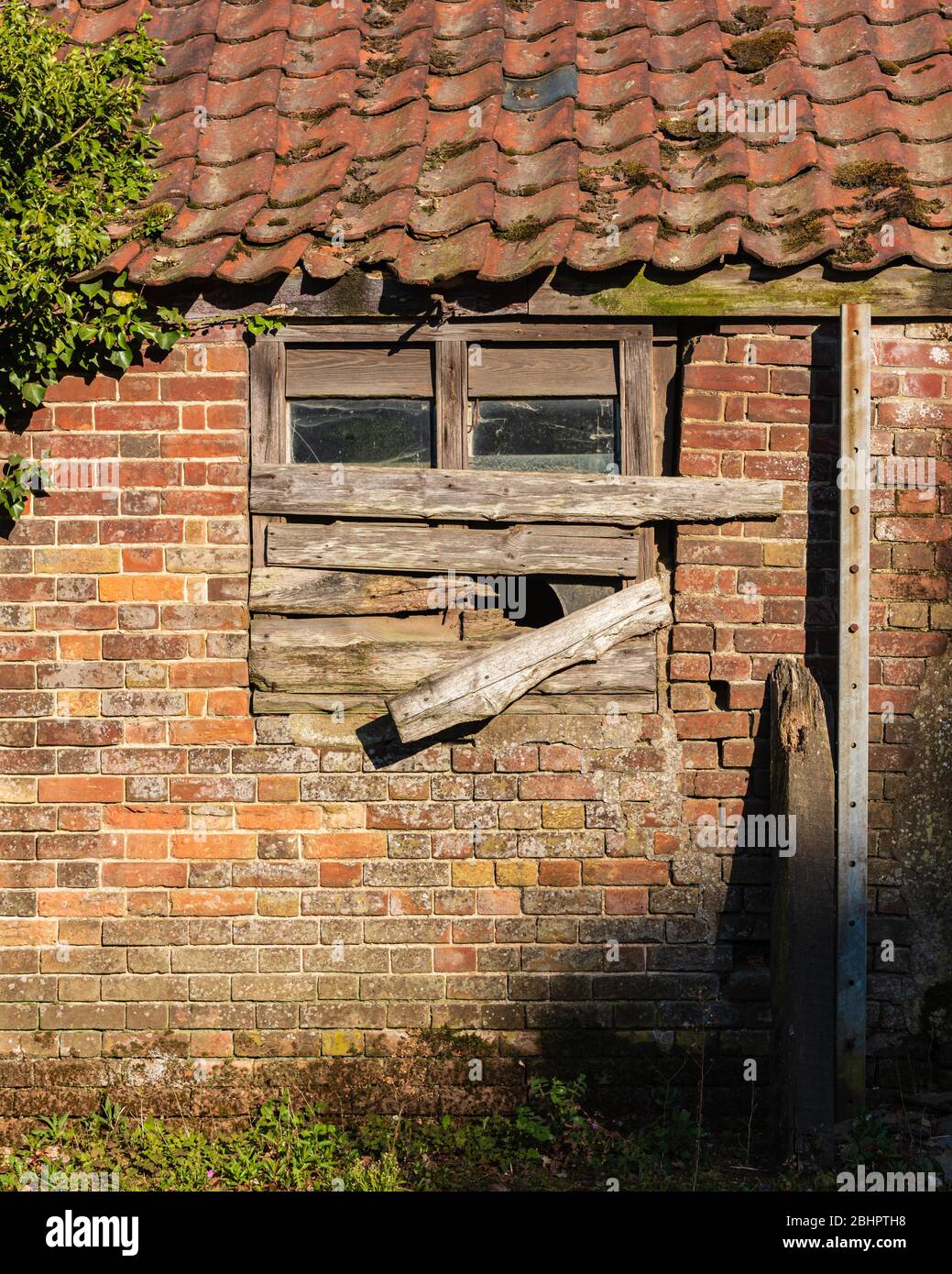 Boarded up window in old abandoned brick building i. April, 2020 Stock ...