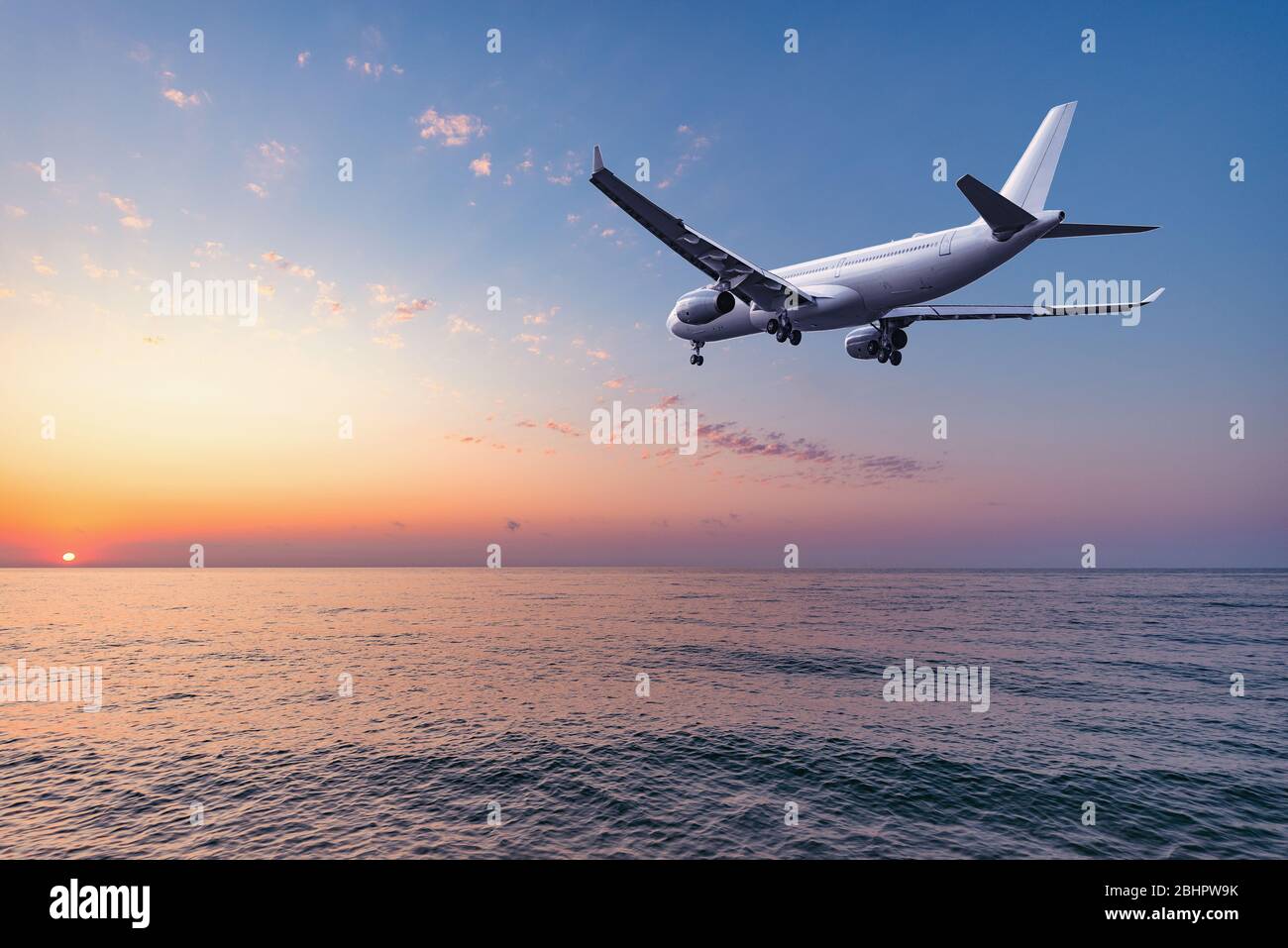 Flight of the plane above the ocean before landing Stock Photo - Alamy