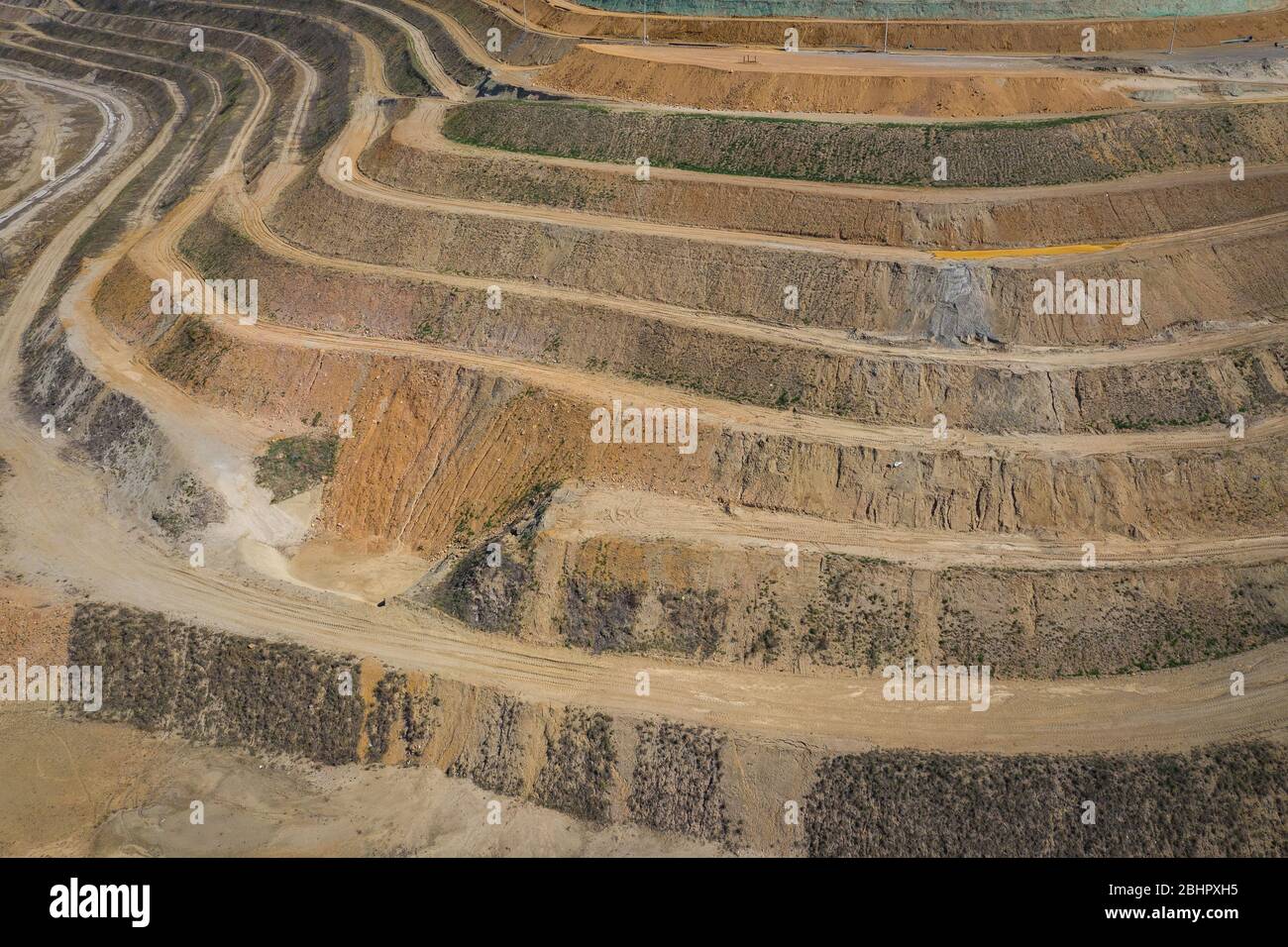 Aerial view of industrial terraces on mineral open pit mine. Opencast ...