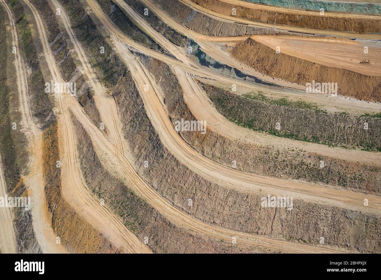 Aerial view of industrial terraces on mineral open pit mine. Opencast ...