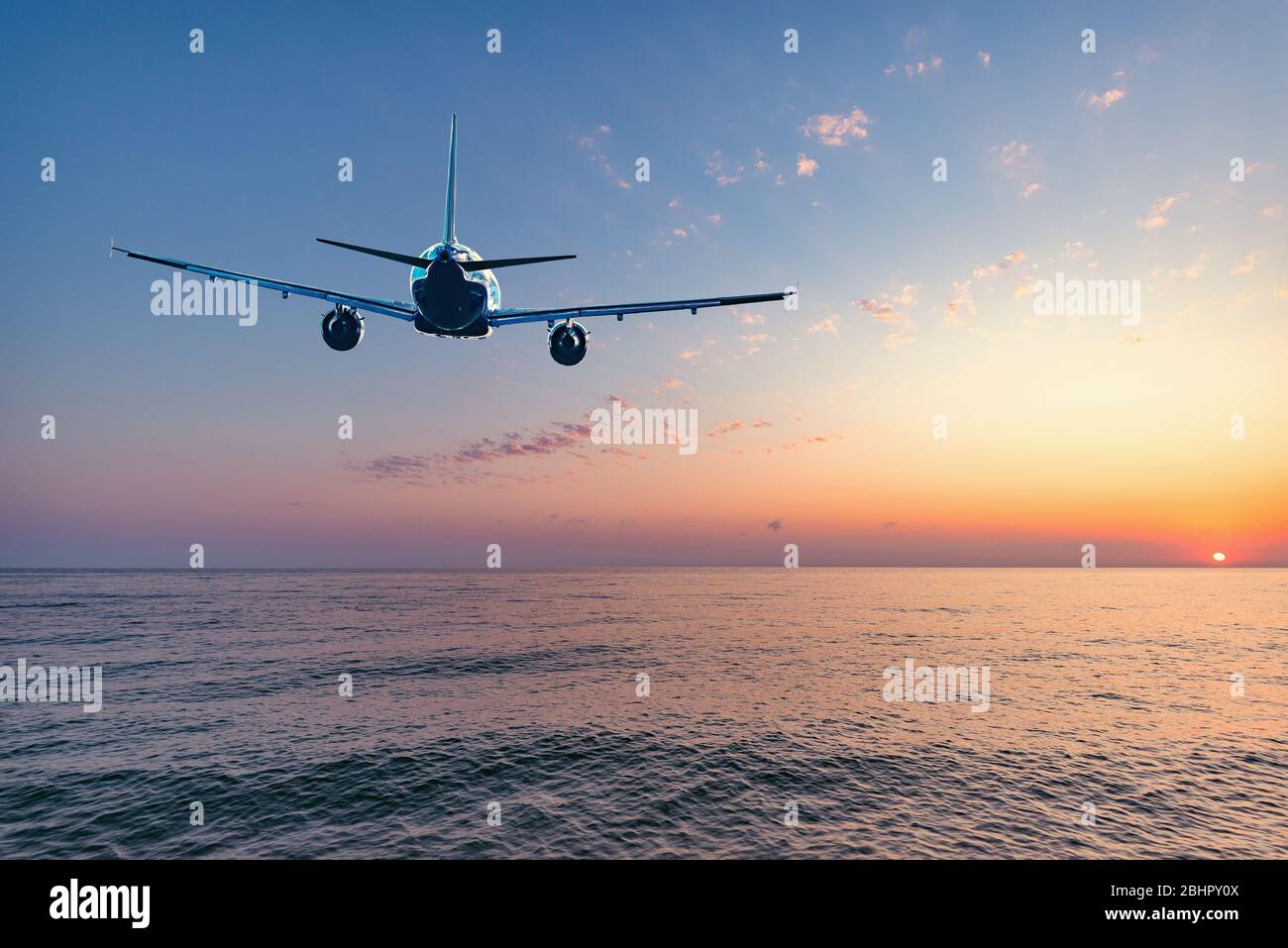 Flight of the plane above the ocean before landing Stock Photo - Alamy
