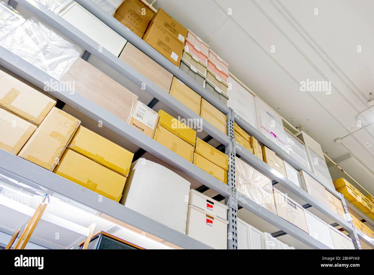 Many sizes and colors parcels stacked on shelves in the Village market ...