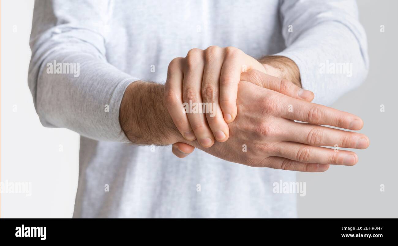 Man holding his hand and feels severe pain Stock Photo - Alamy