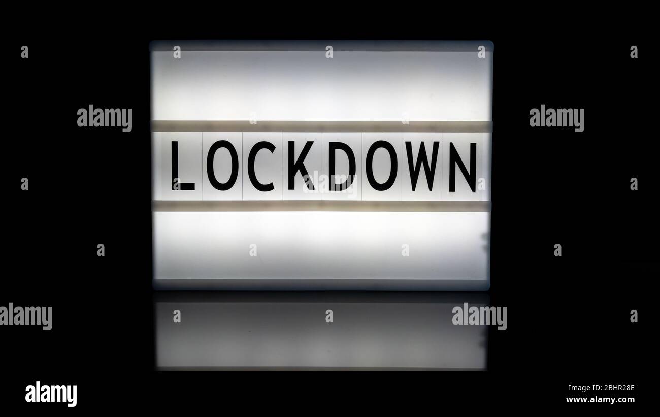 Lockdown letters on a light box on reflective surface Stock Photo - Alamy