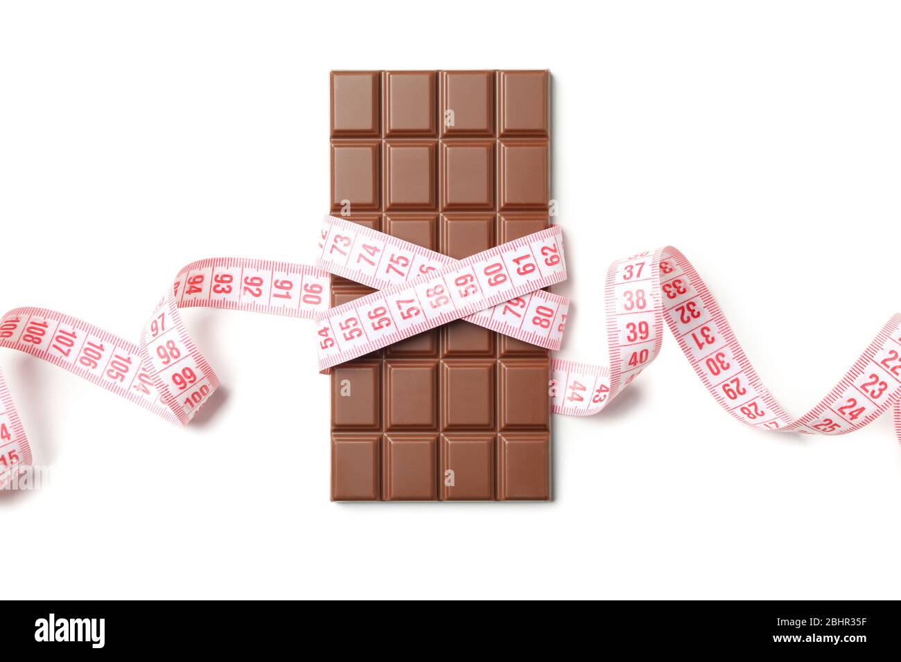 Measuring tape and chocolate bar on white background Stock Photo - Alamy