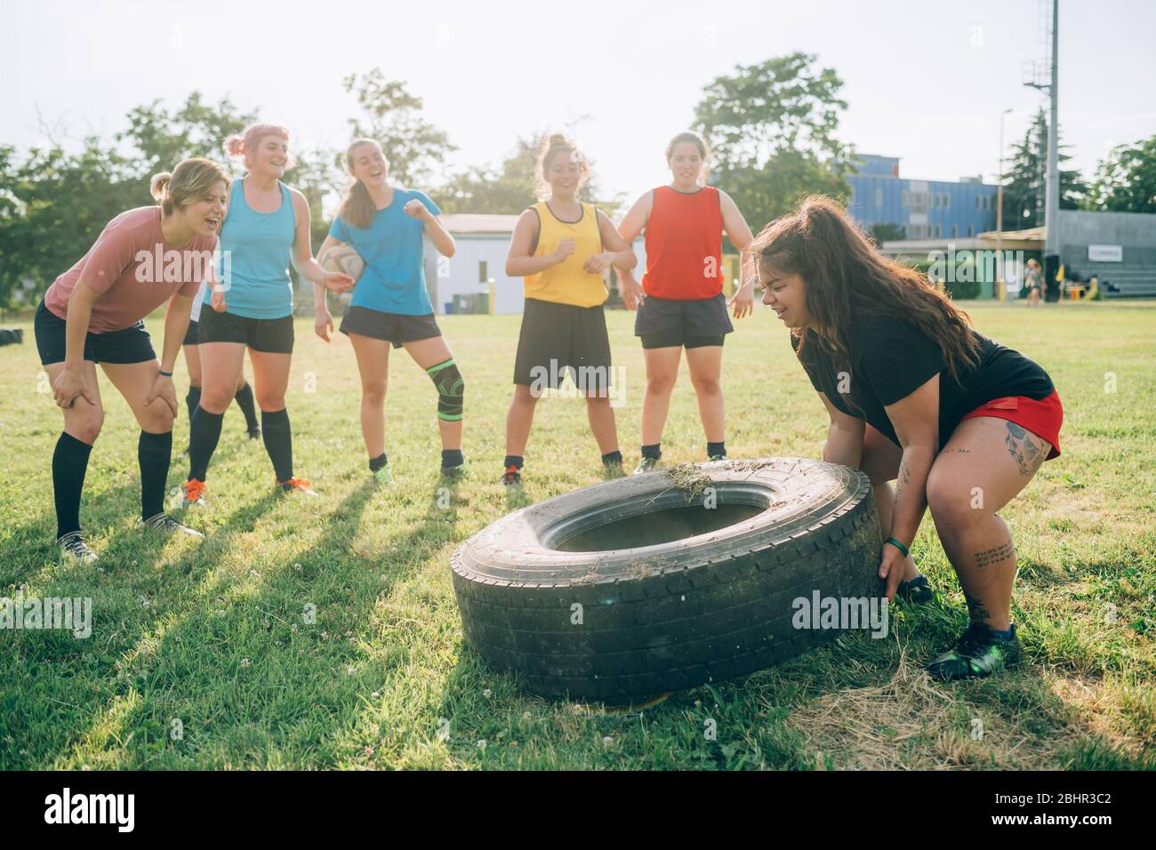 Seven women at rugby training one lifting a tyre Stock Photo - Alamy