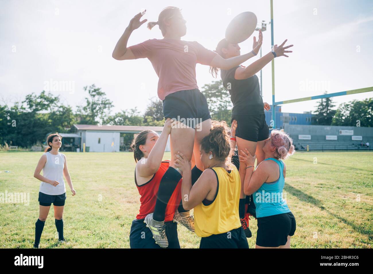 A group of women practicing for rugby lineouts on a training pitch ...