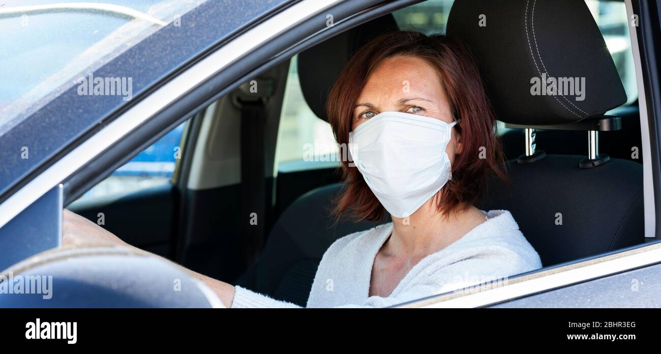 Woman wearing mask in her car Stock Photo - Alamy