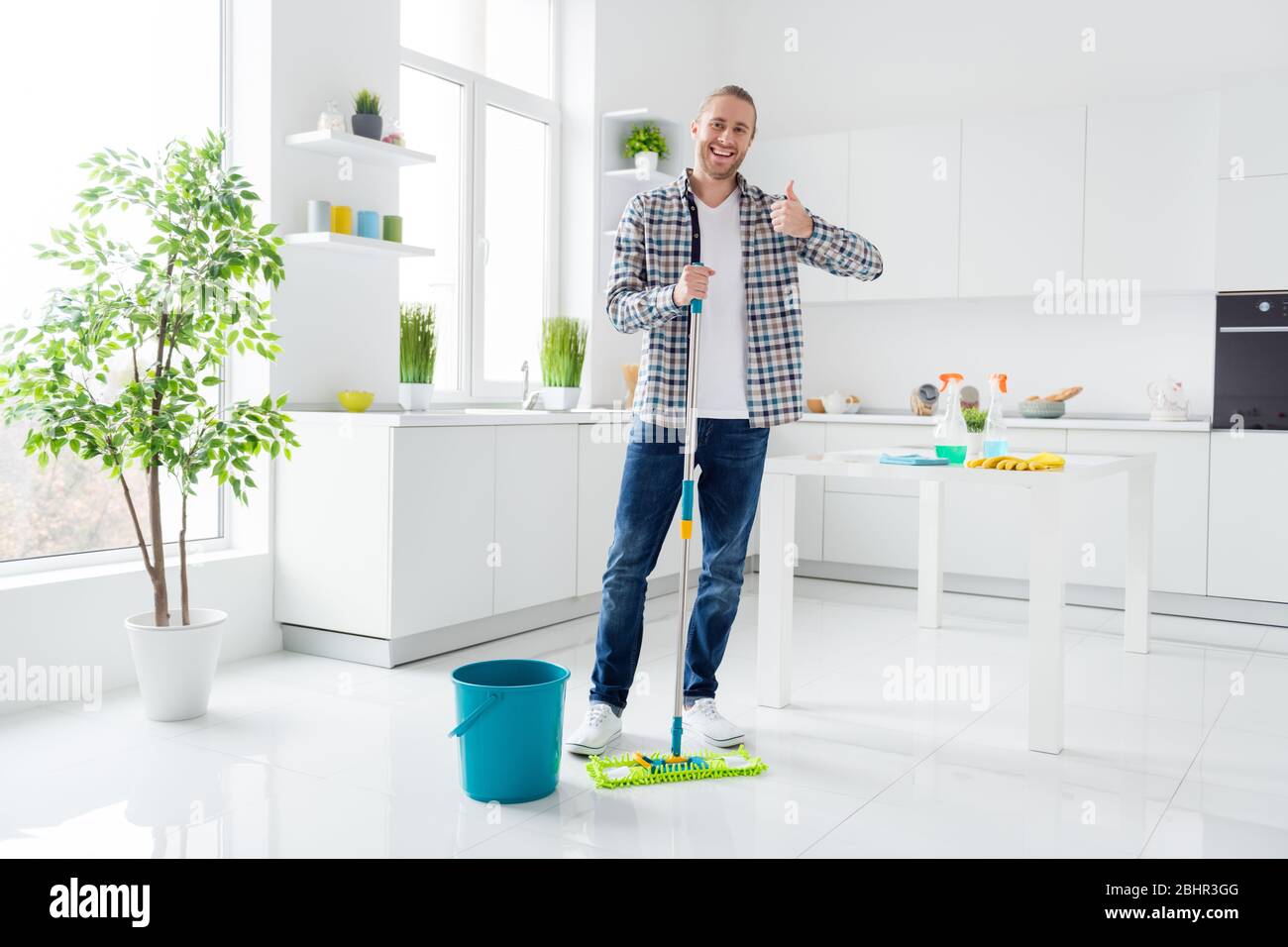 Full body photo of positive guy hold mop have cleaning cleanup service ...