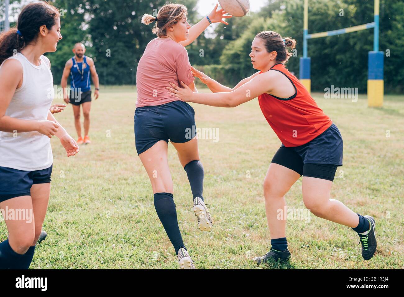 A group of women during rugby training being watched by their male ...