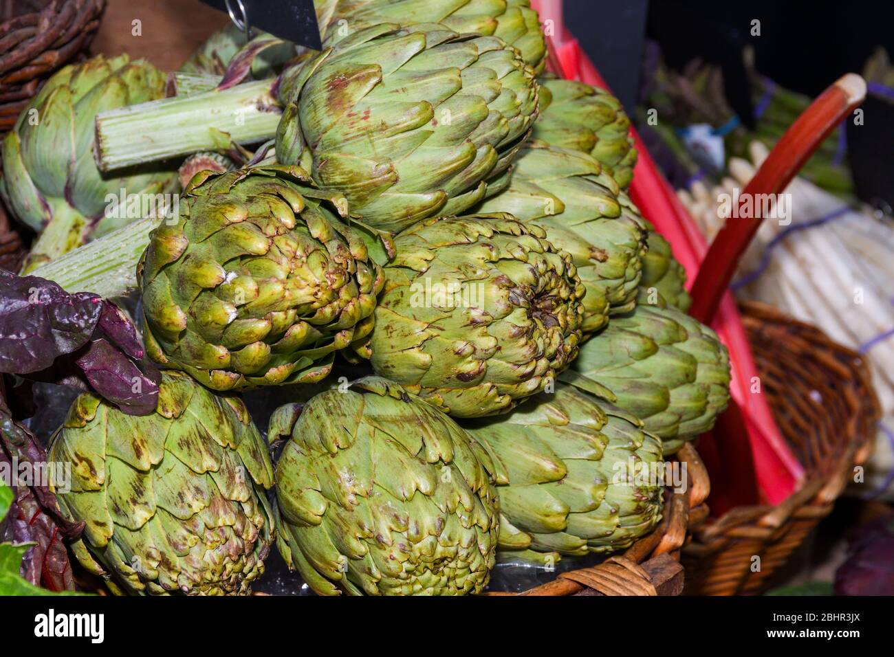 Green and red artichoke.Local produce for sale displayed at the market ...