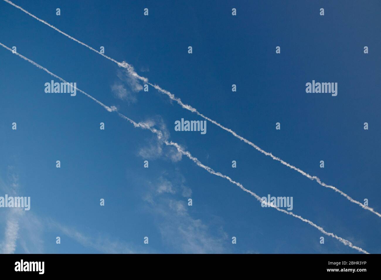 two contrails on the blue sky Stock Photo - Alamy