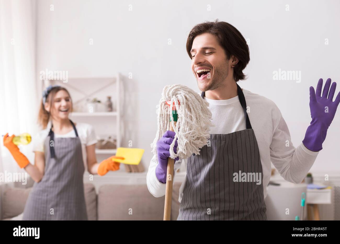 Jouful Housekeeping Happy Young Couple Having Fun While Cleaning Home