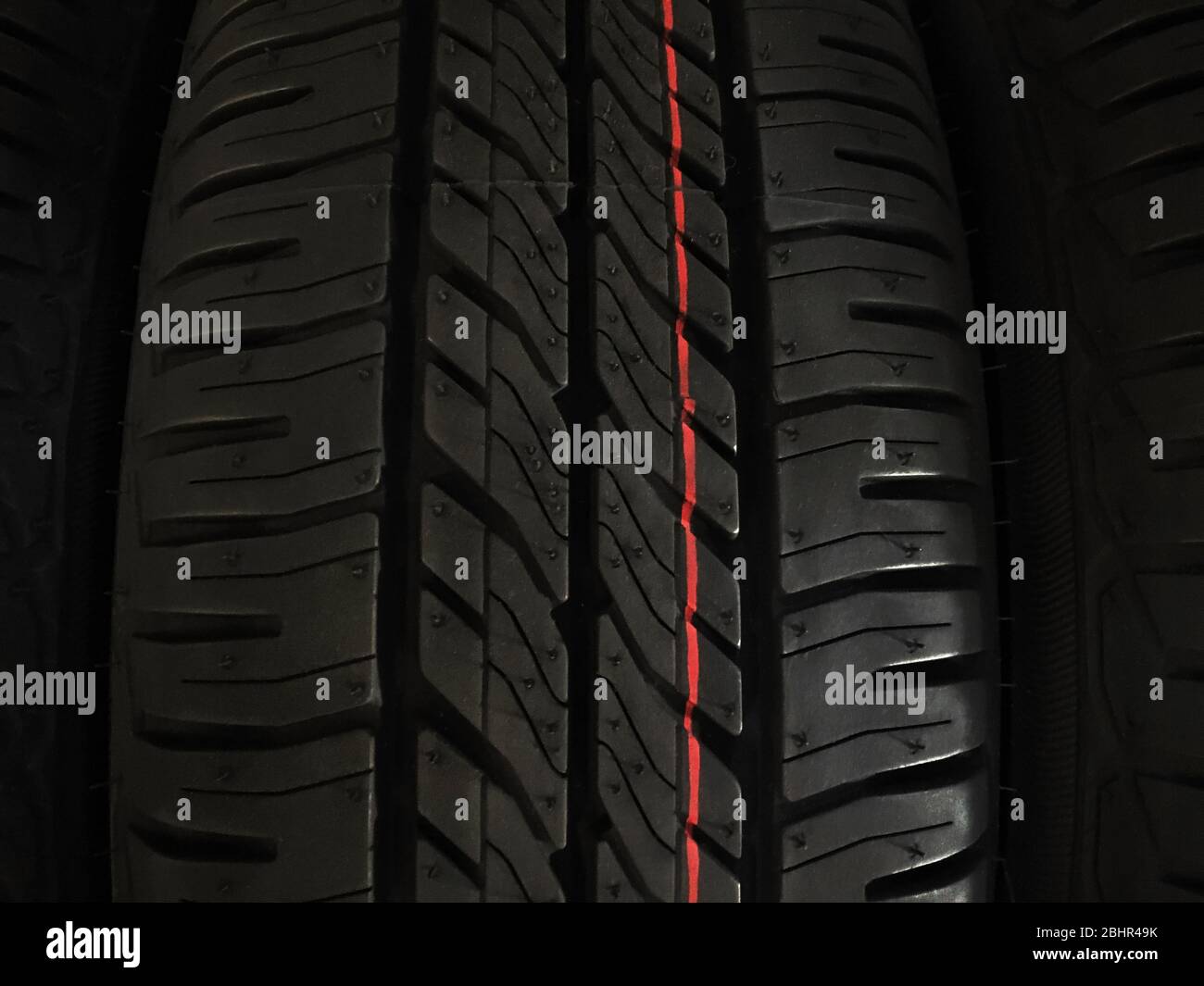 The new black tyres with safety red line Stock Photo - Alamy