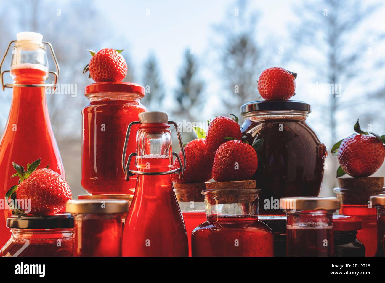 Homemade syrup and jam, preserved in glass bottles and jars. Delicious ...
