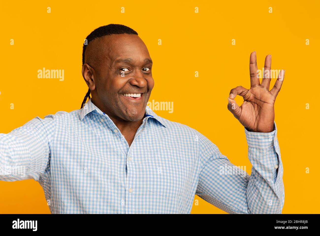 Happy middle aged african man making selfie and showing OK Stock Photo ...