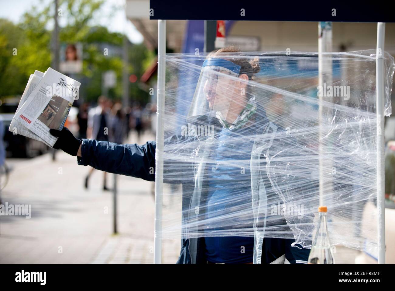 Berlin, Germany. 27th Apr, 2020. A newspaper promoter with a face ...