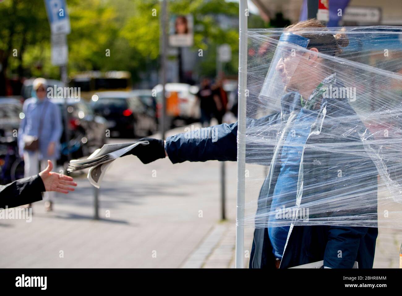 Berlin, Germany. 27th Apr, 2020. A newspaper promoter with a face ...