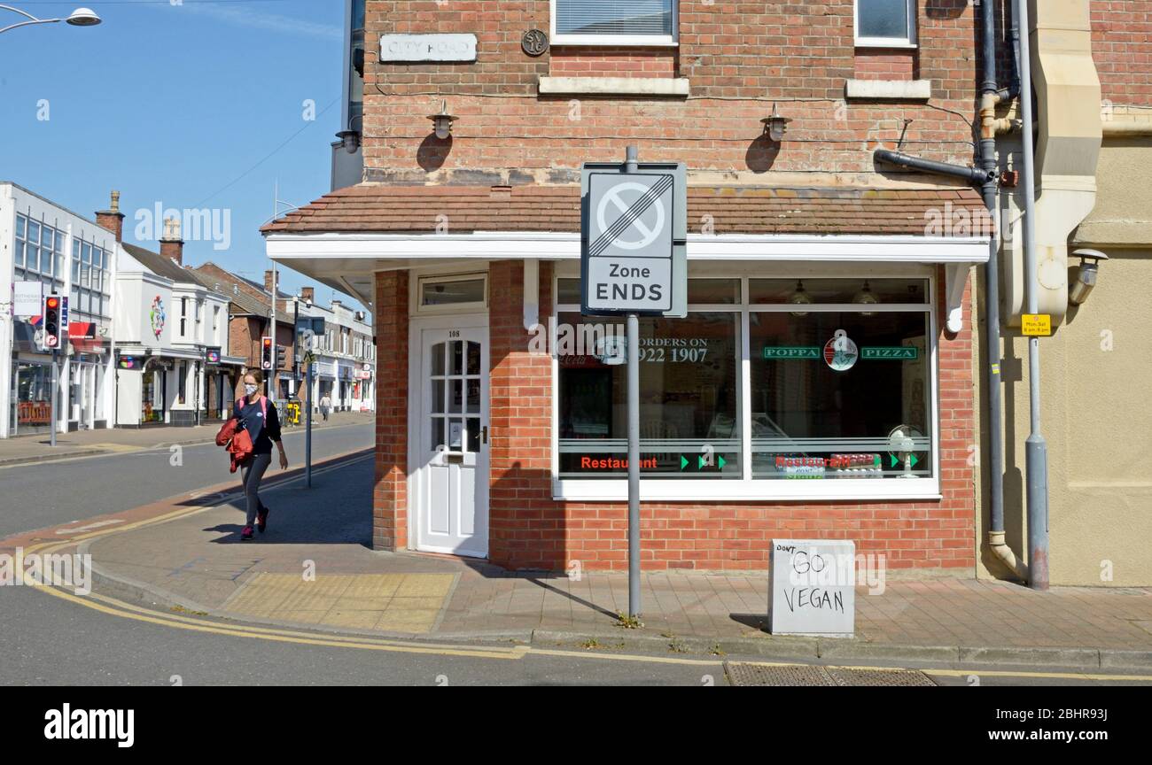 Lady in mask, steps into the light on a corner Stock Photo - Alamy