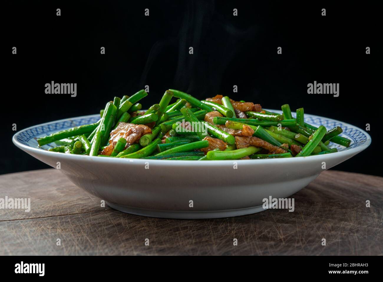 Stir-fried pork with garlic sprouts, Chinese Food Stock Photo - Alamy