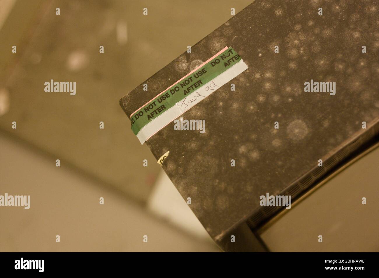 An electric convector heater radiator bears a sticker stating "do not ...