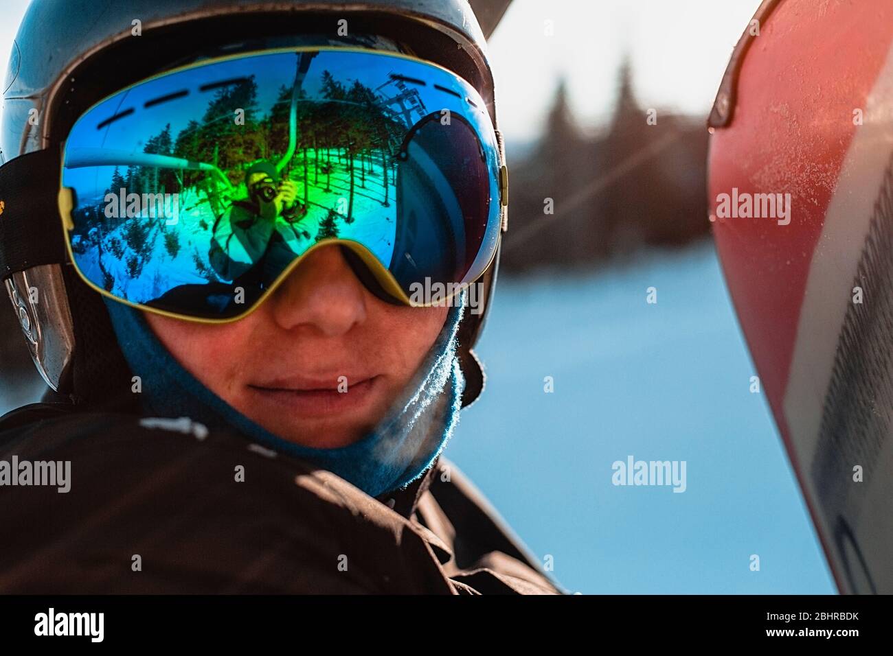 Head and shoulders of person wearing a black helmet and dark goggles on ...