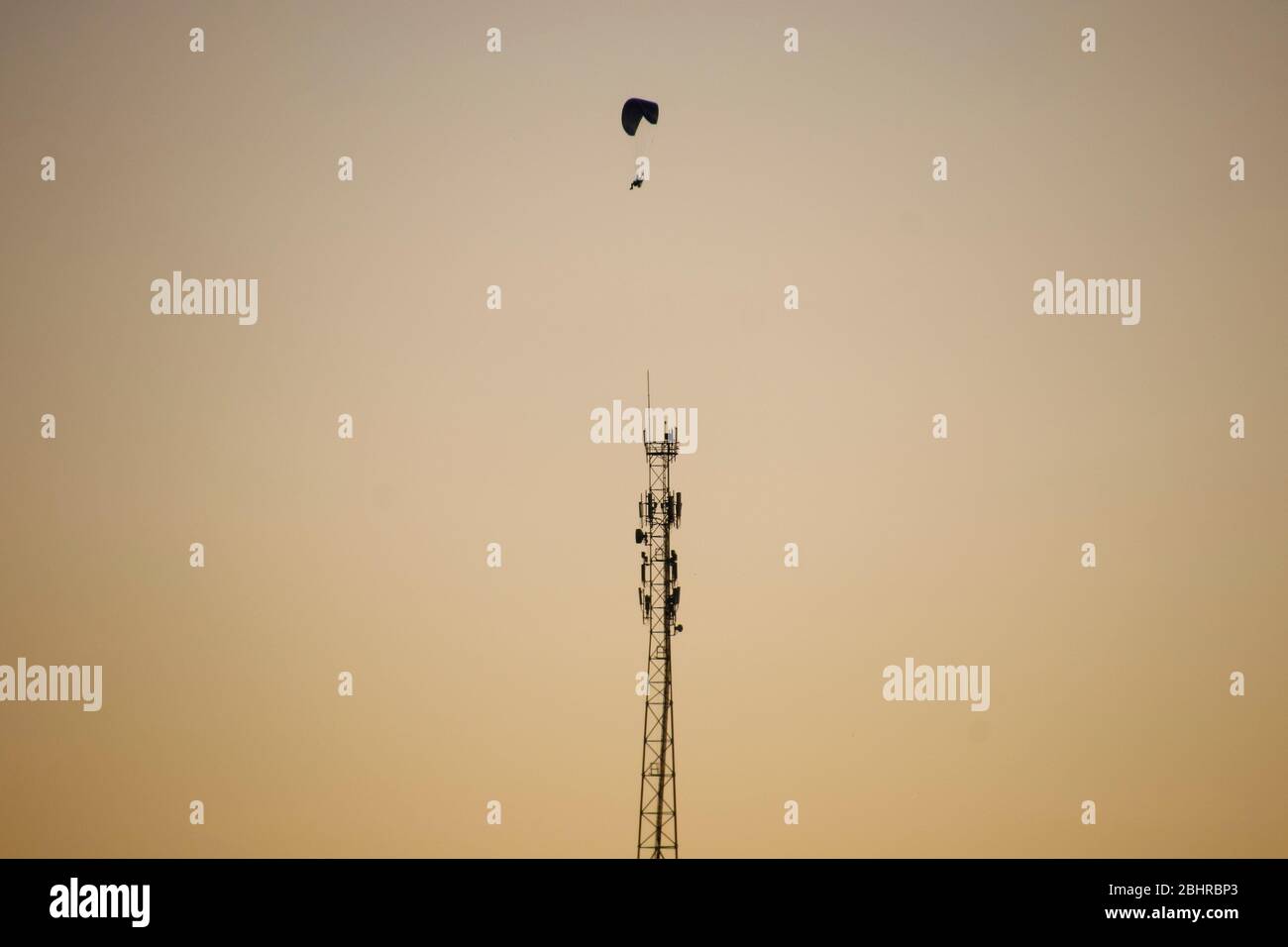 engine parachute flight above cell phone telecommunication tower Stock ...