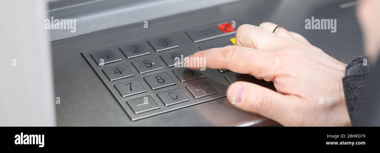 Closeup male hand dials pin code on terminal Stock Photo - Alamy