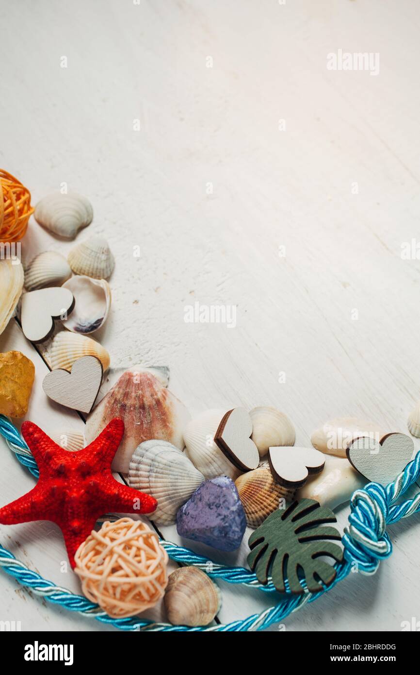 Summer background. Different types of seashells, rope on wooden ...