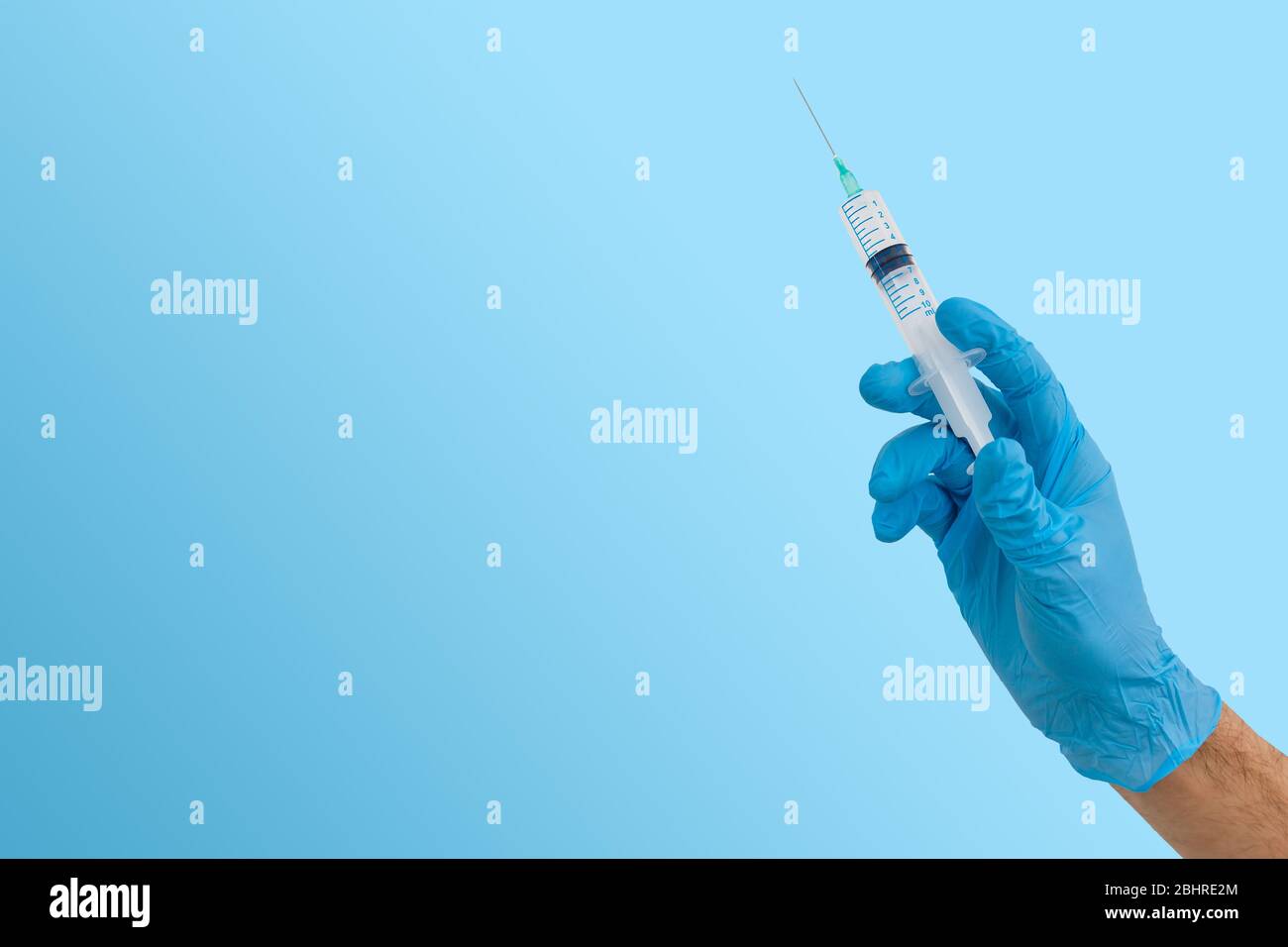 Hand holding syringe isolated on white Stock Photo - Alamy