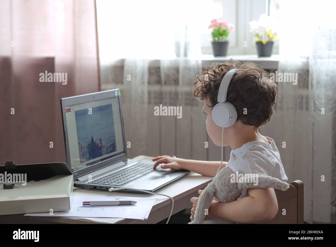 Little boy doing his homework. Home schooling, distance learning ...