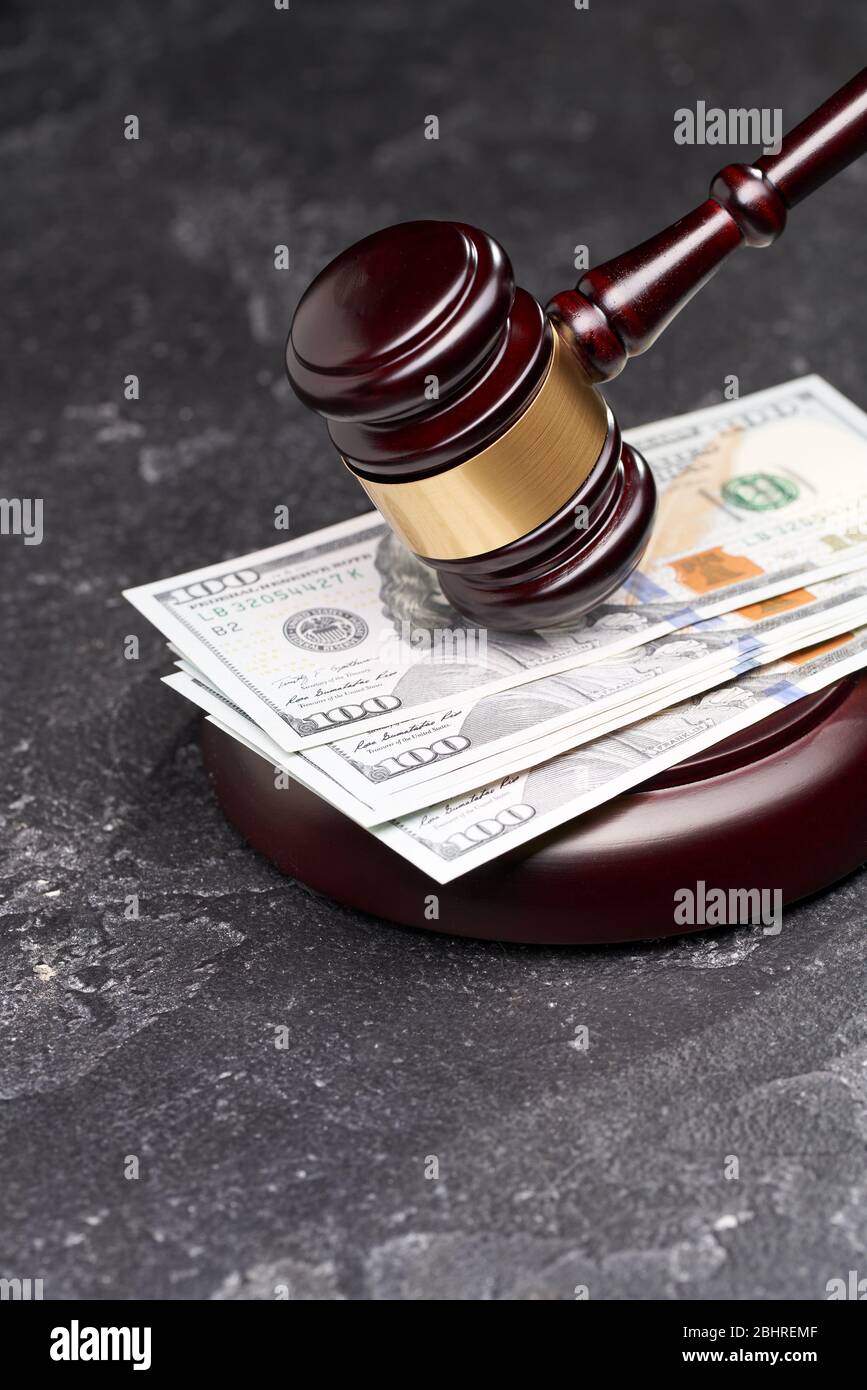 Symbol of court and justice, judge's hammer, banknotes on black ...