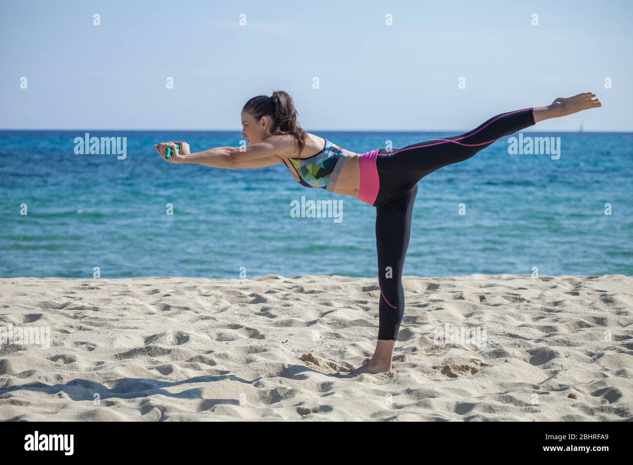 Woman doing yoga sandy hi-res stock photography and images - Alamy
