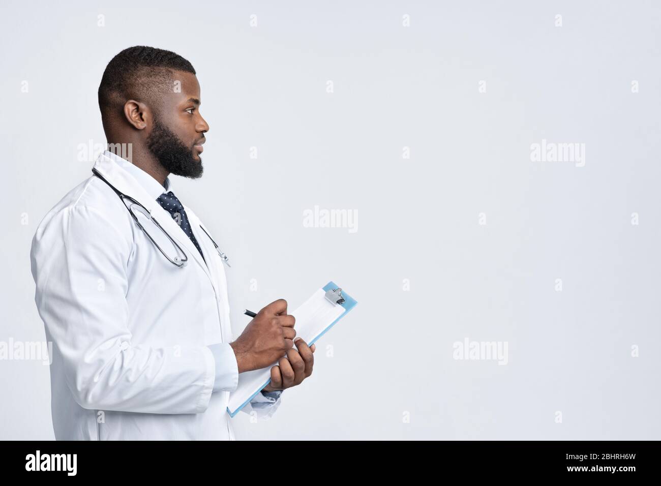 Black doc working over white background, holding medical chart Stock ...