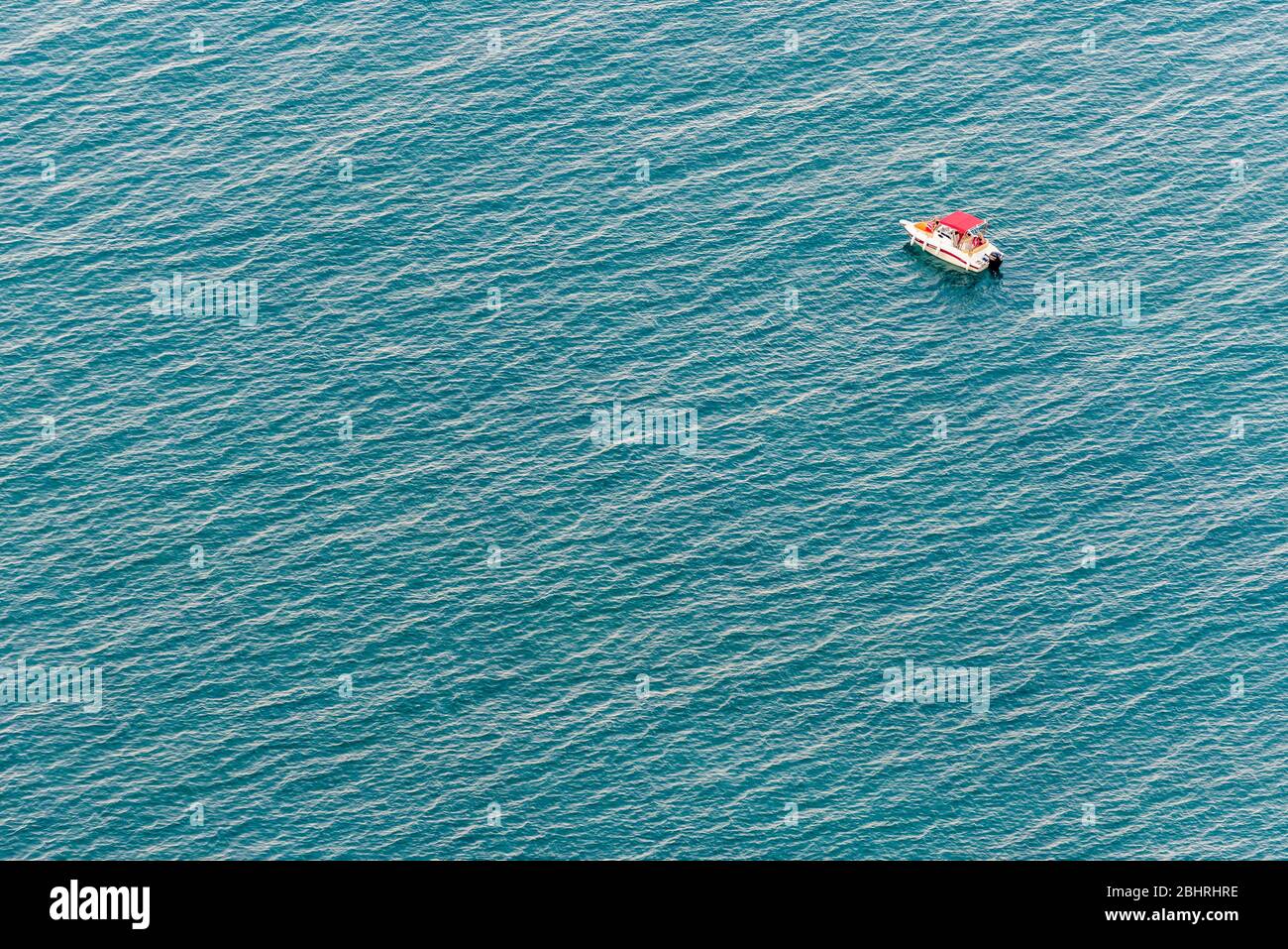 Aerial view of the sea surface and a solitary boat. High resolution ...