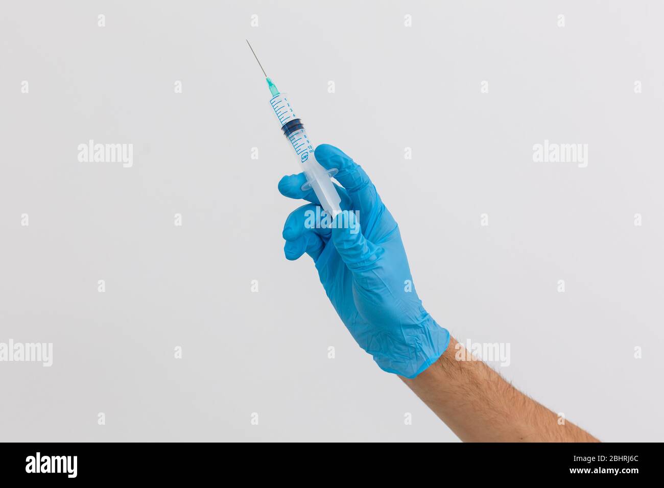 Hand holding syringe isolated on white Stock Photo - Alamy
