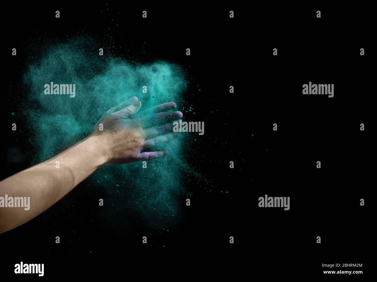 Cloud of dry blue paint around hands on black background Stock Photo ...