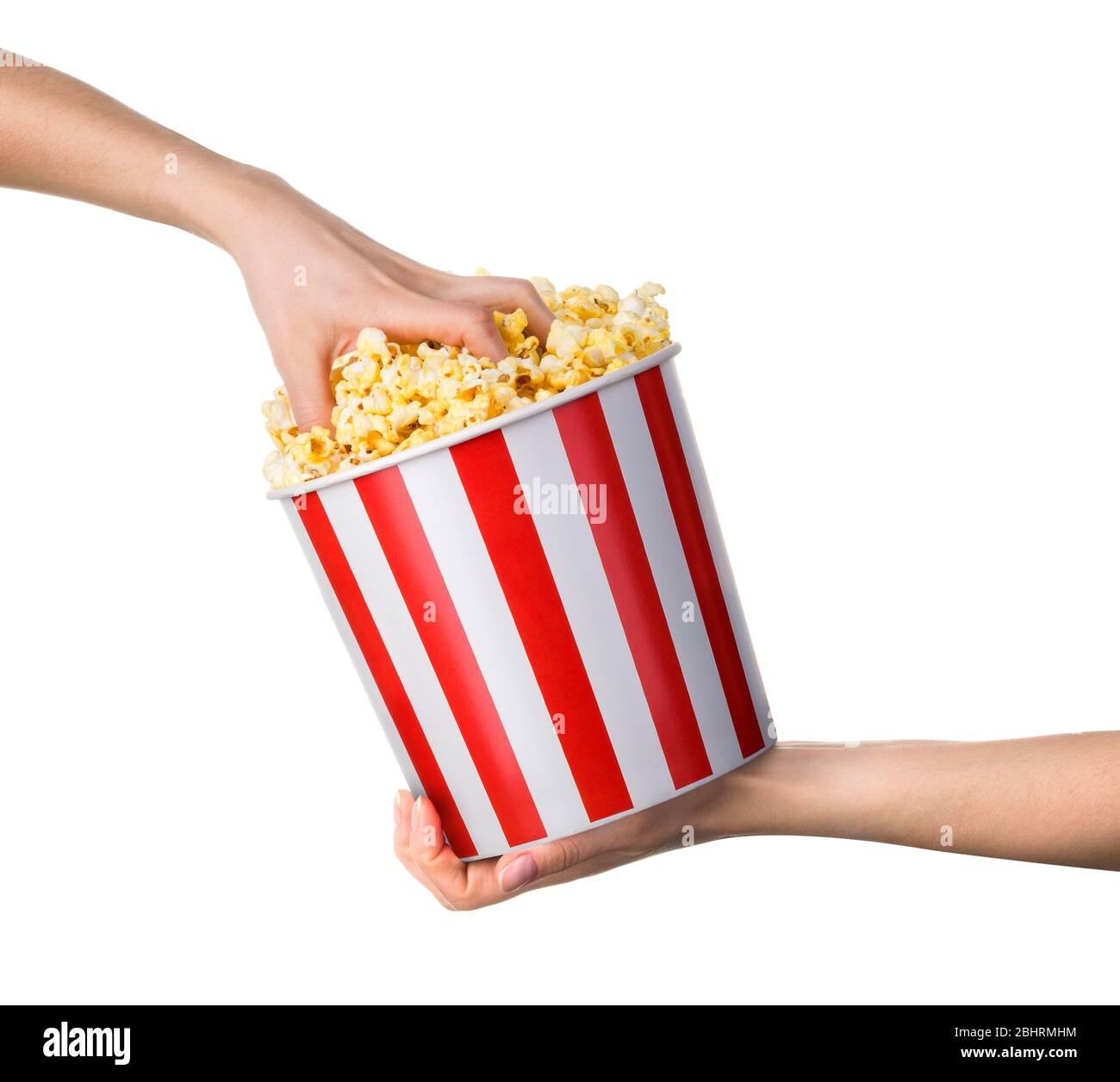 Woman hand taking popcorn from striped bucket isolated on white ...