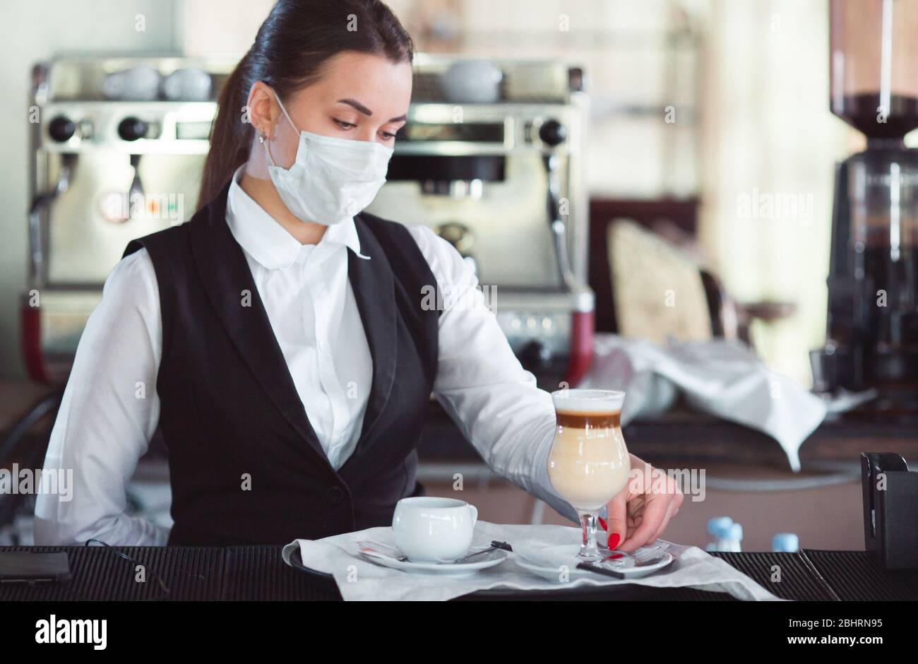 work of a waiter in a restaurant in a medical mask Stock Photo - Alamy