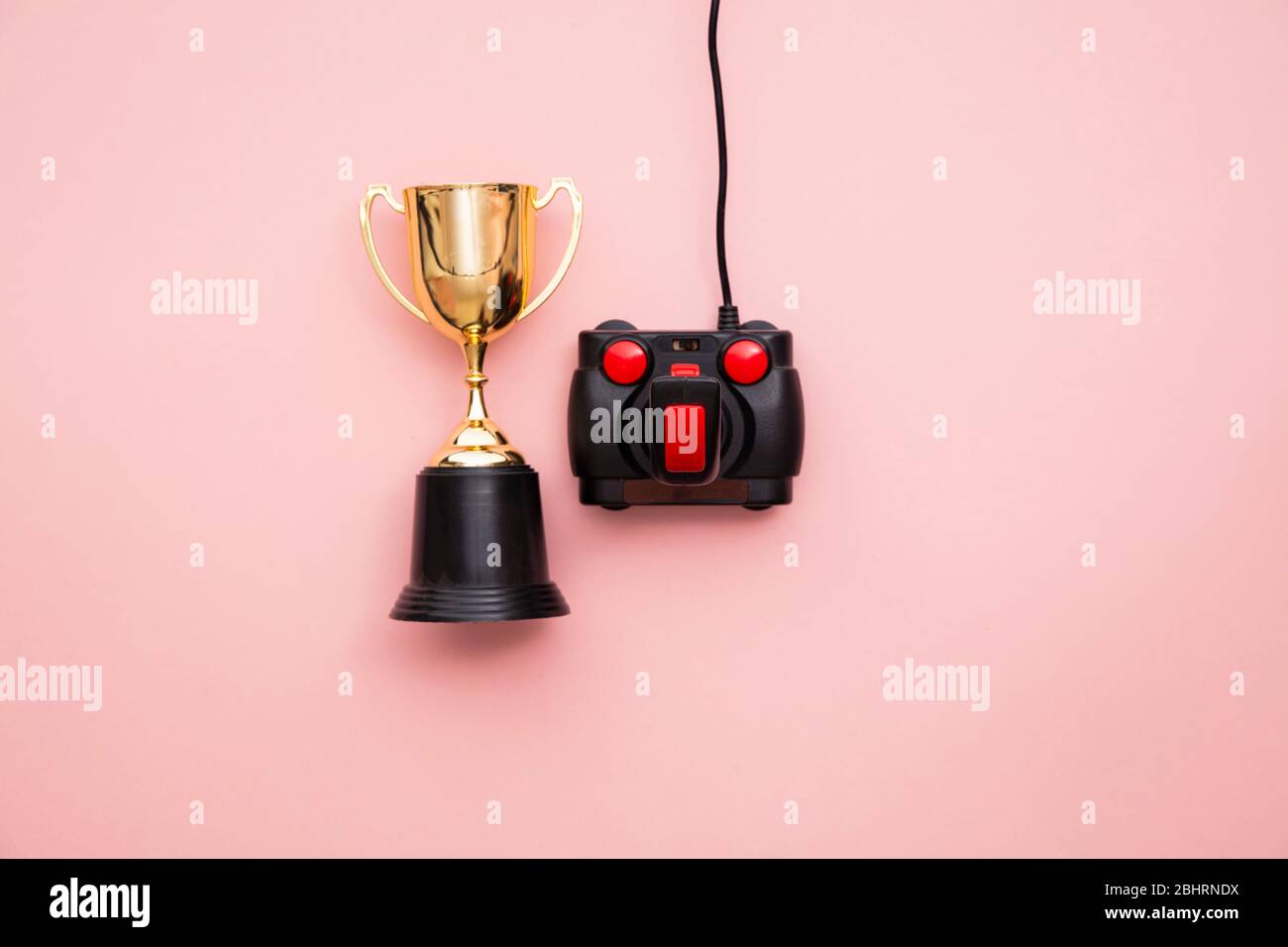winning gamer. A retro games joystick with a gold winning trophy Stock ...