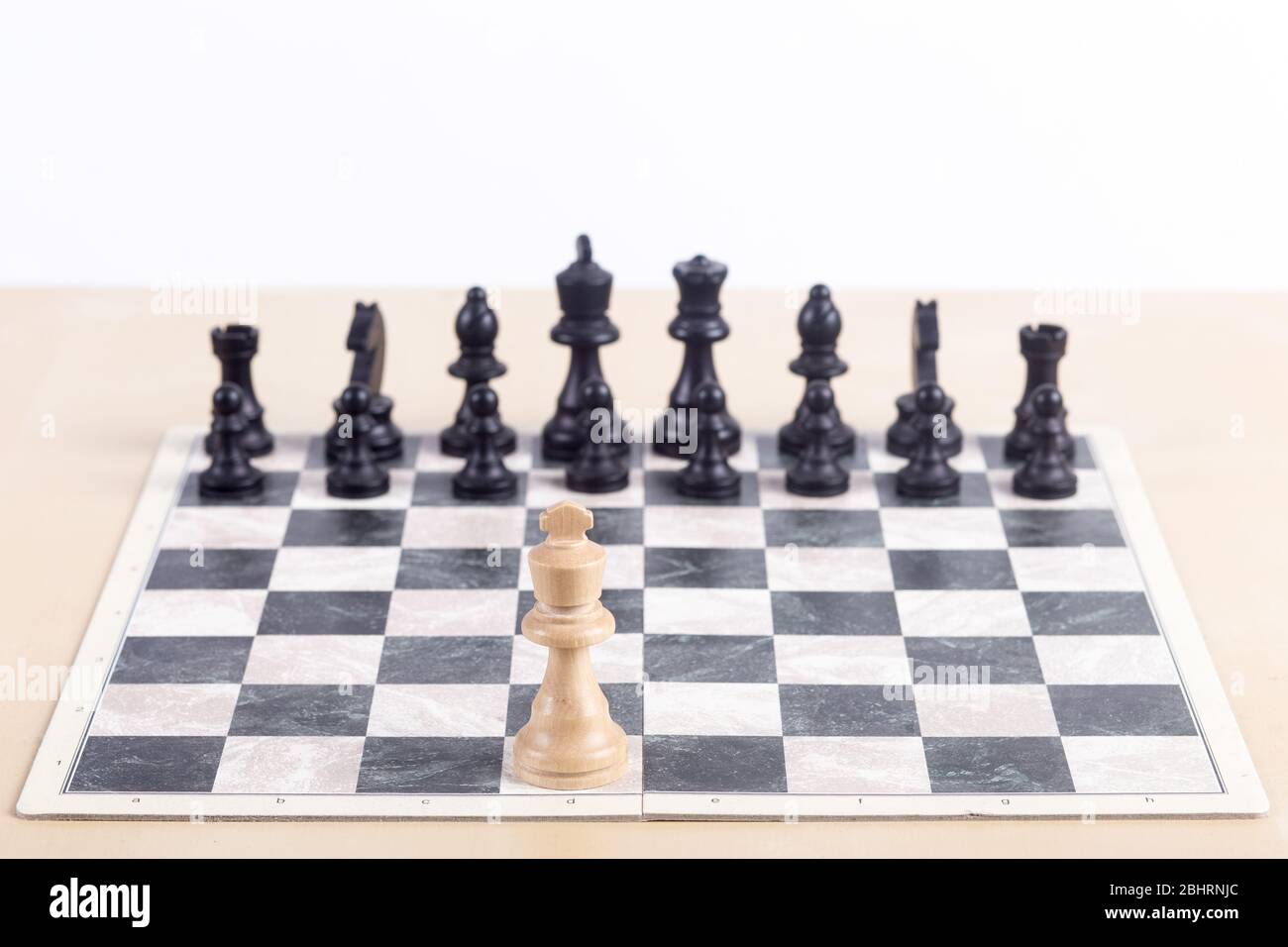 Close up of chess board with all the black pieces at start position and ...