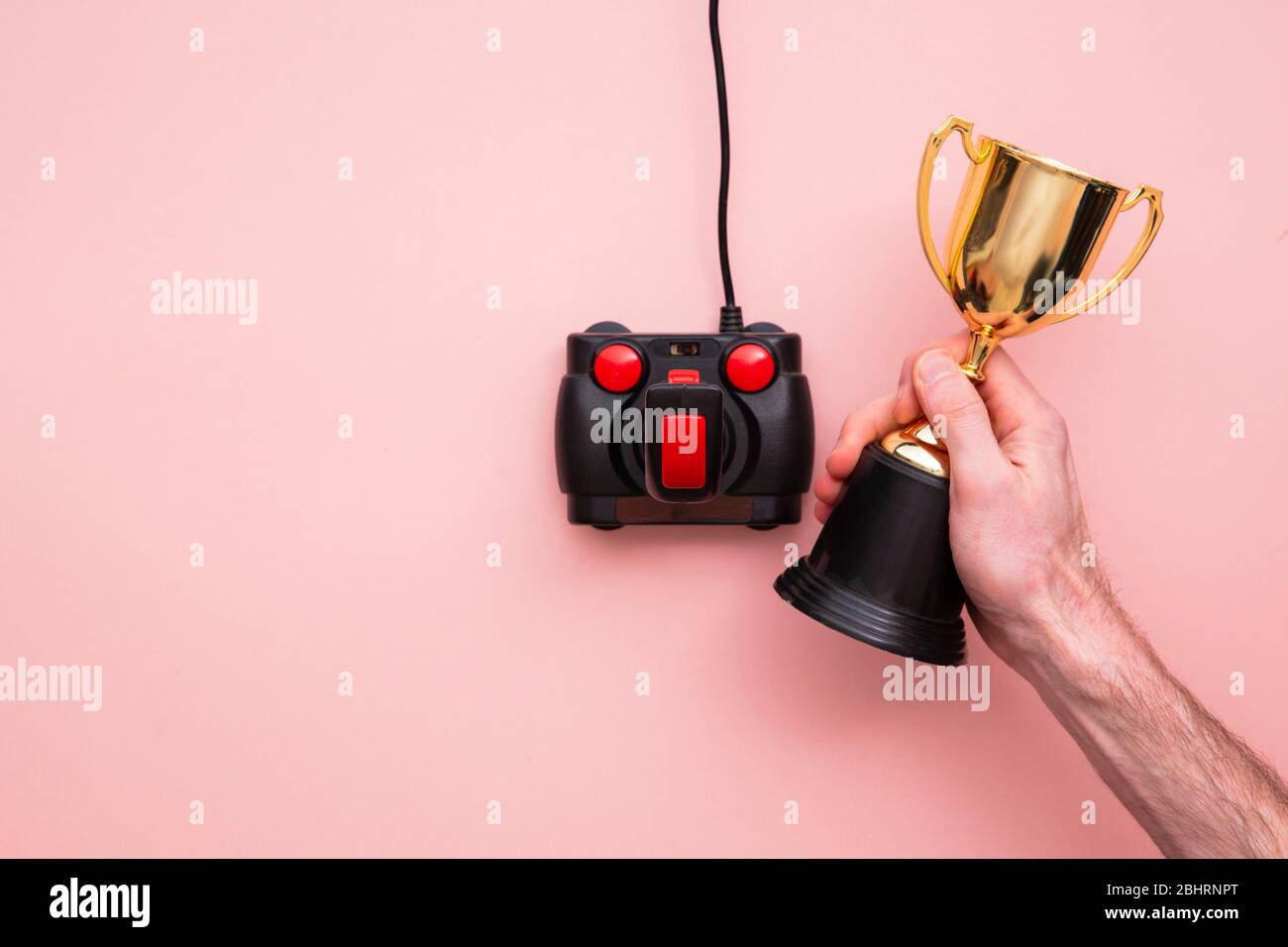 winning gamer. Hand using a retro games joystick with a gold winning ...
