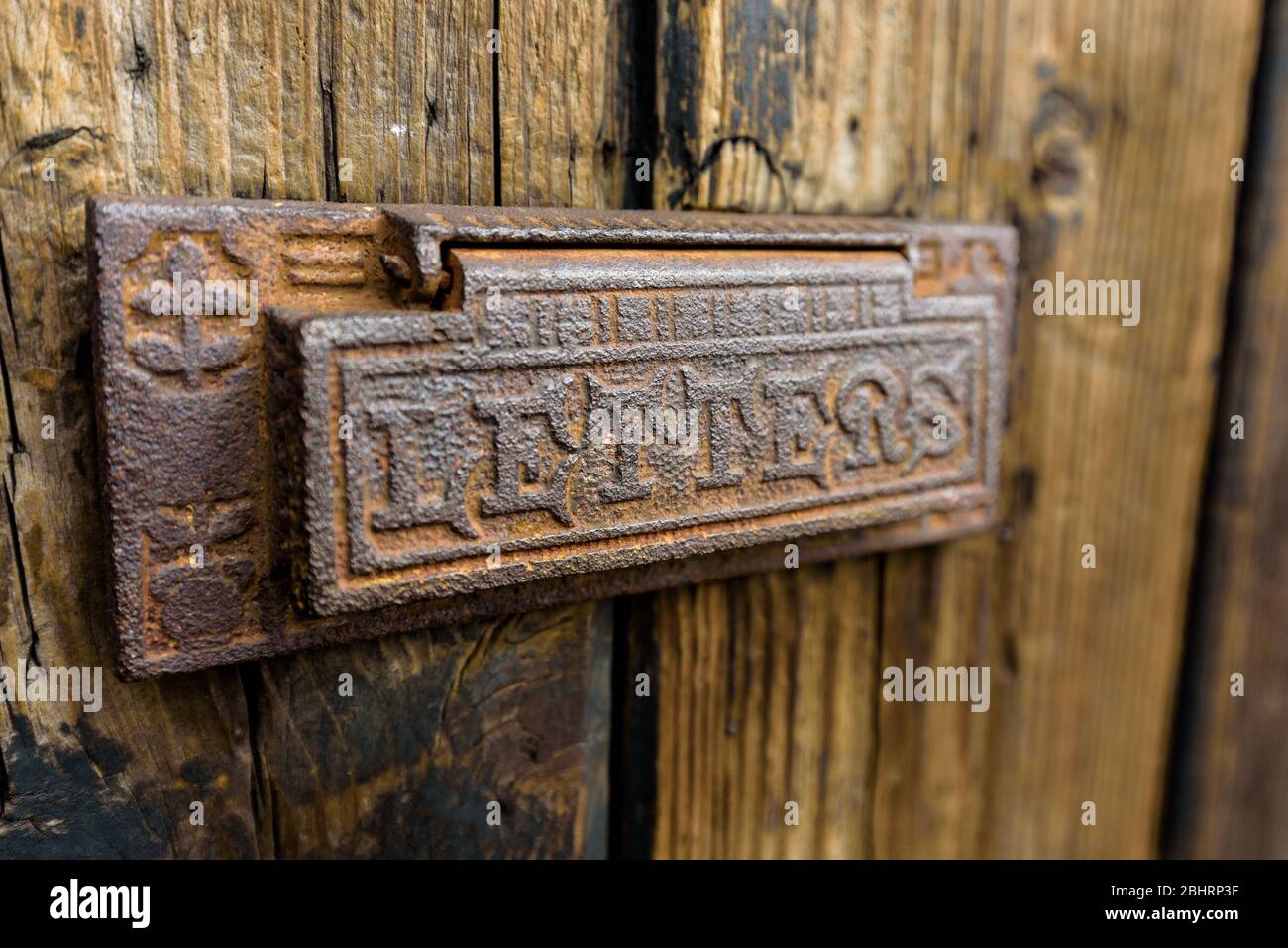 Old metal brown rusty letter box. Vintage mailbox on a wooden ...