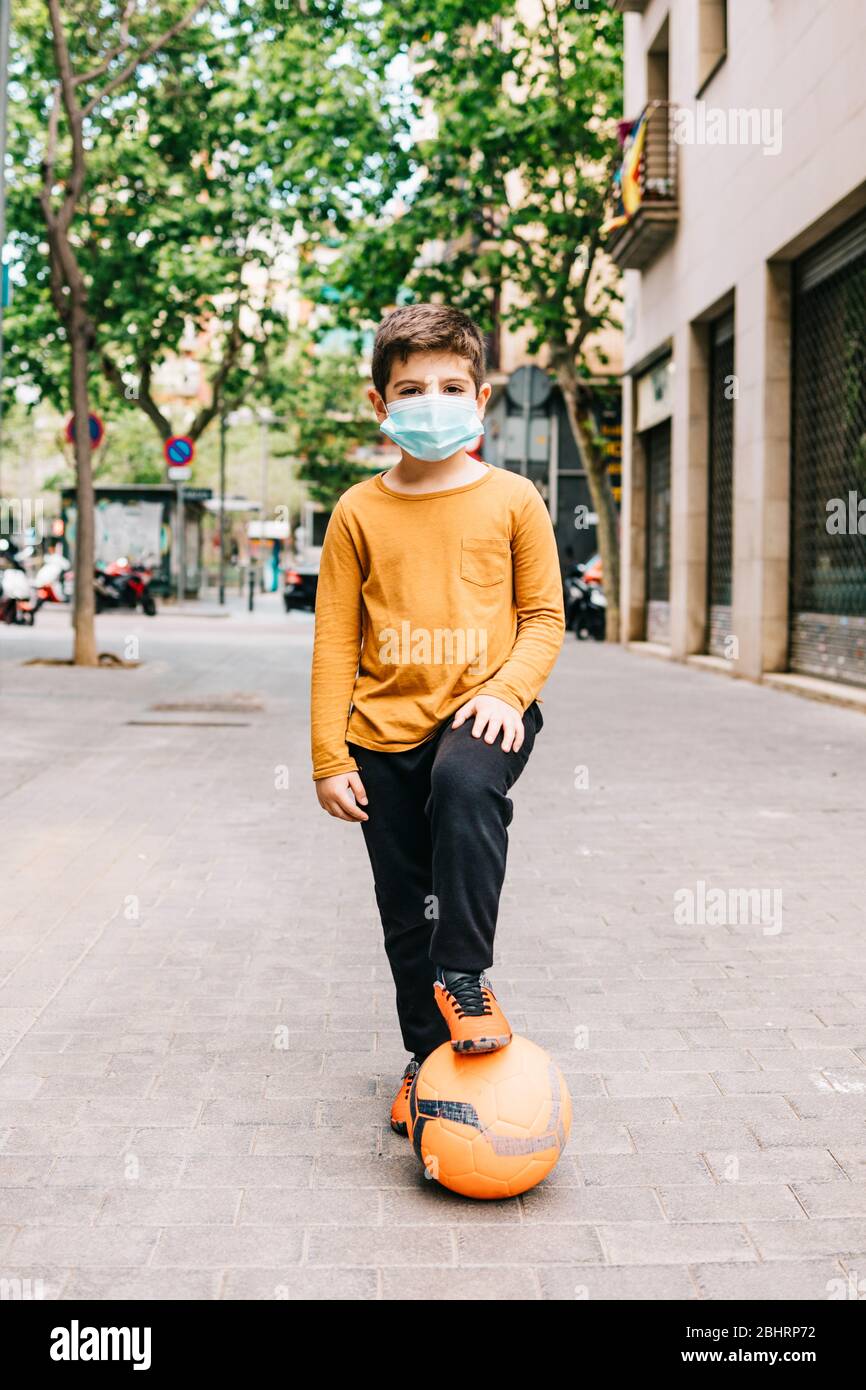 Little boy playing football with a mask Stock Photo - Alamy