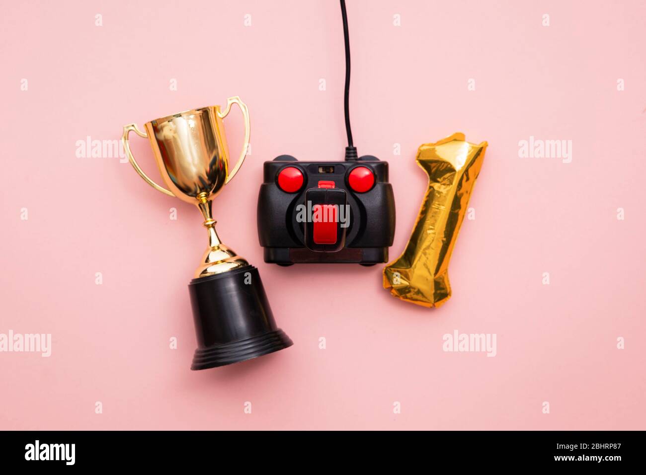 winning gamer. A retro games joystick with a gold winning trophy Stock ...