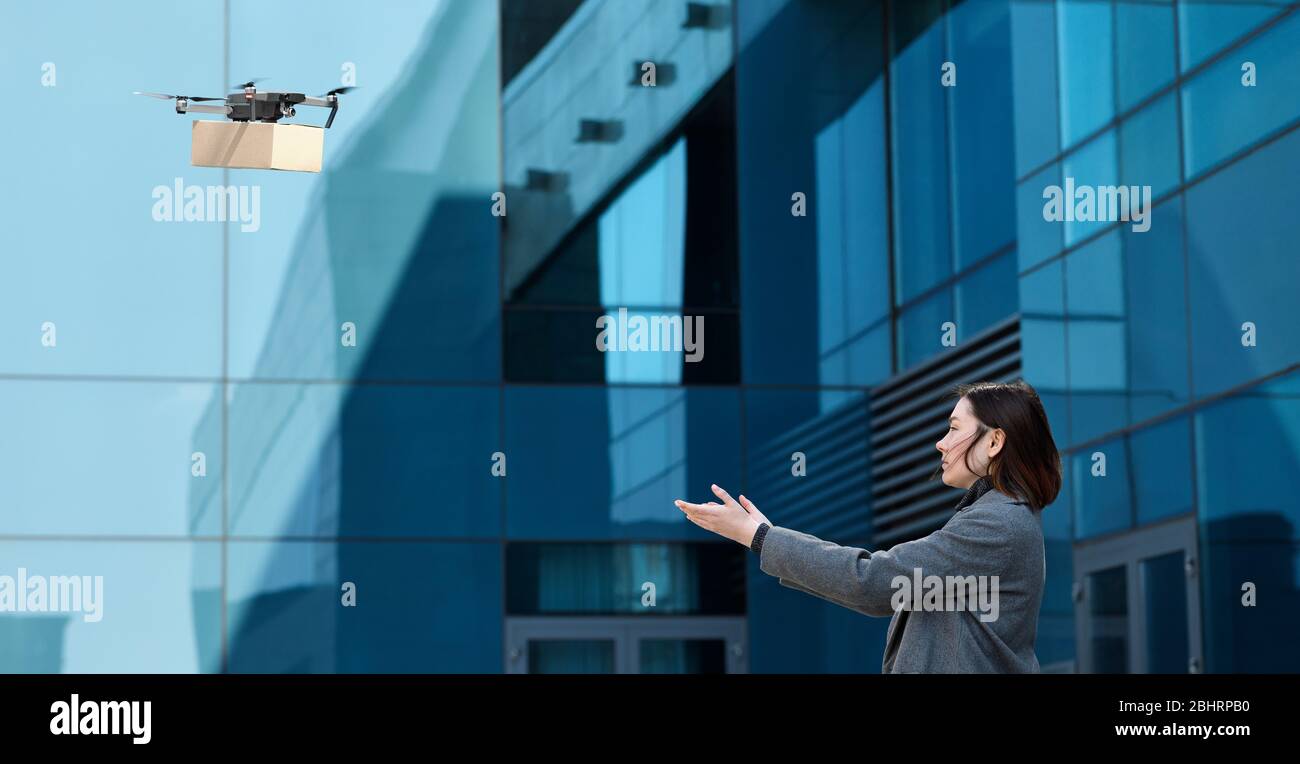 Modern drone quadcopter delivering Packages and transported in high ...
