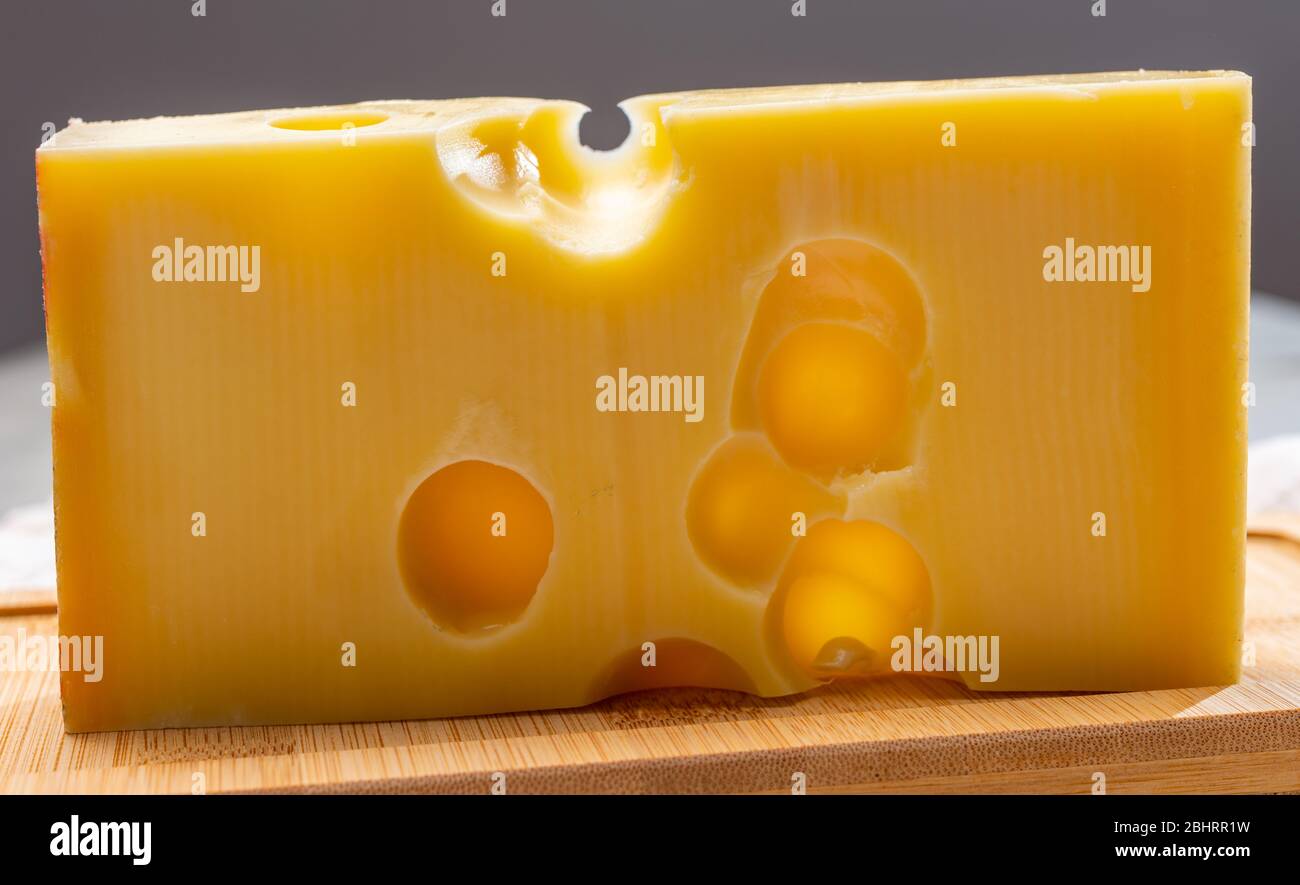 Block of Swiss medium-hard yellow cheese emmental or emmentaler with ...